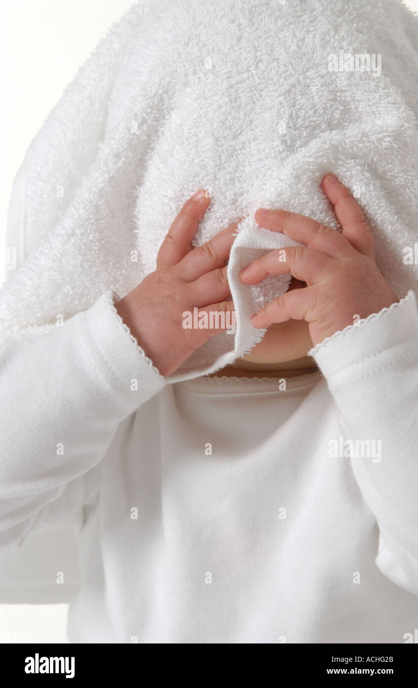 Baby hiding away behind towel Stock Photo - Alamy