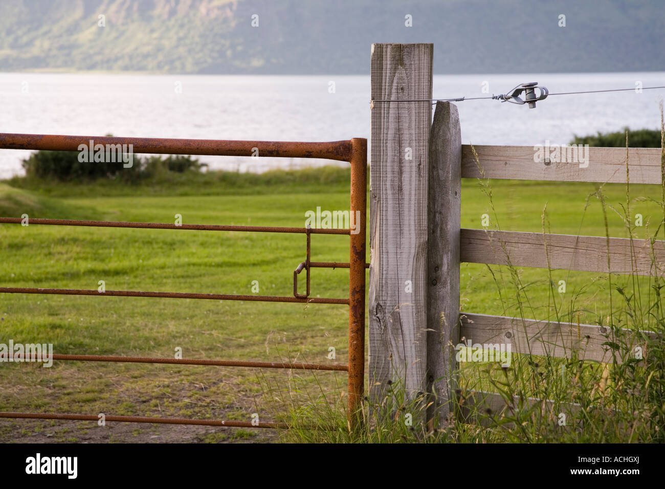 Fence and gate to farm field Stock Photo - Alamy