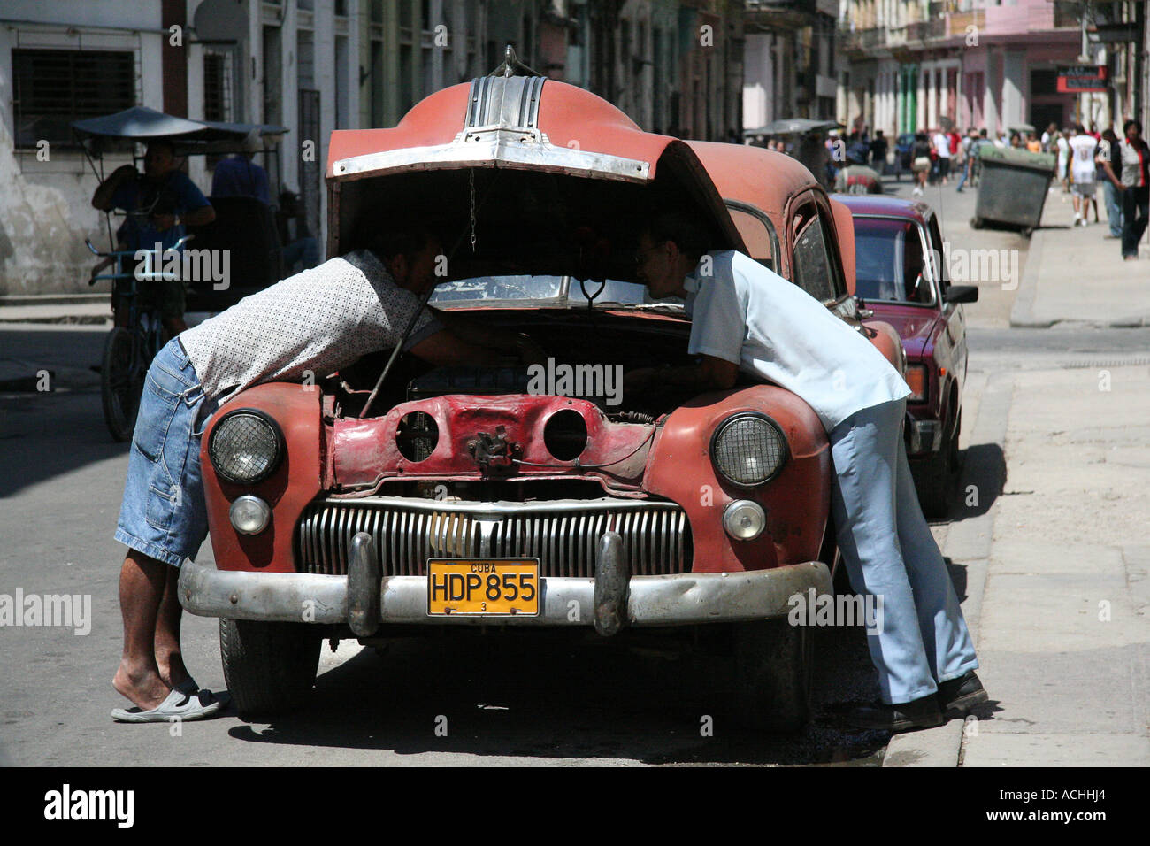 Two men fixing a car Stock Photo - Alamy