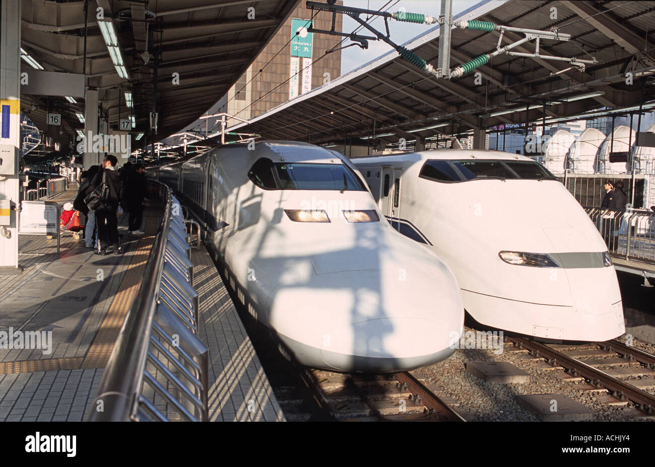 Two Shinkansen trains of different styles side by side at Tokyo Station ...