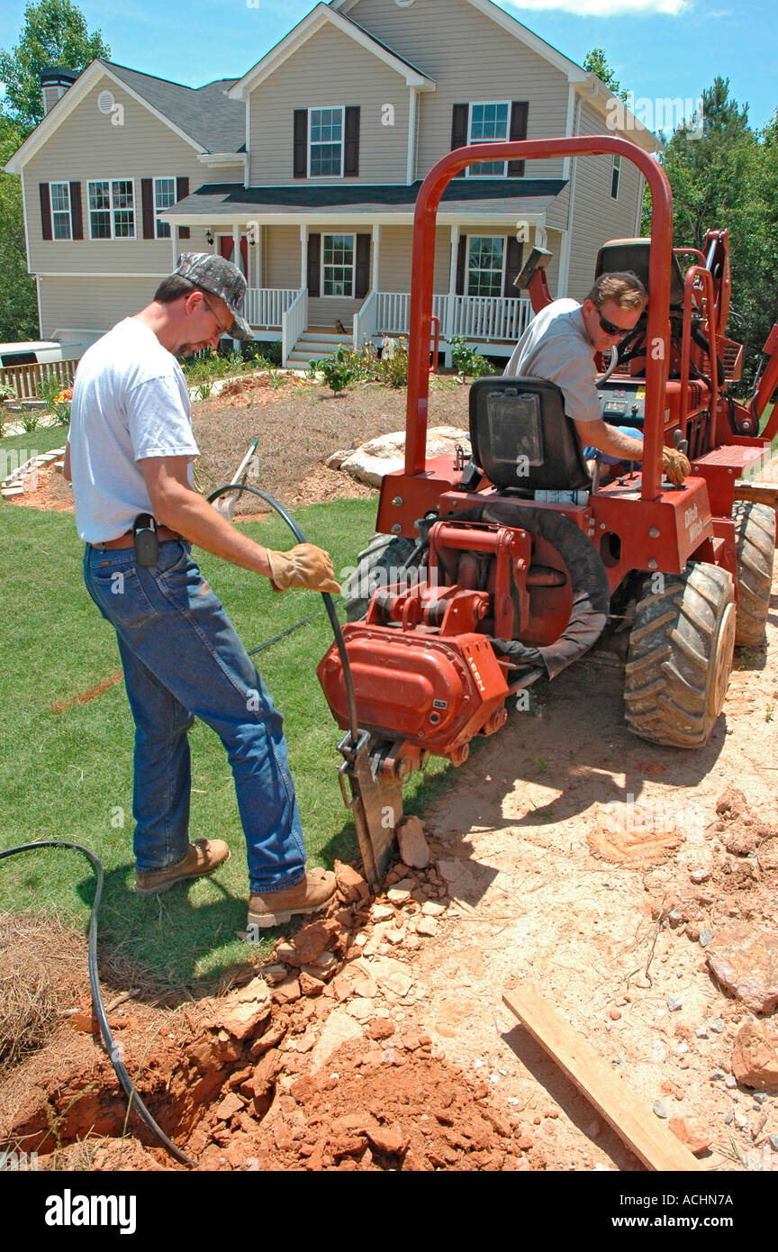 Installing underground TV and Phone cable line using shaker on tractor ...