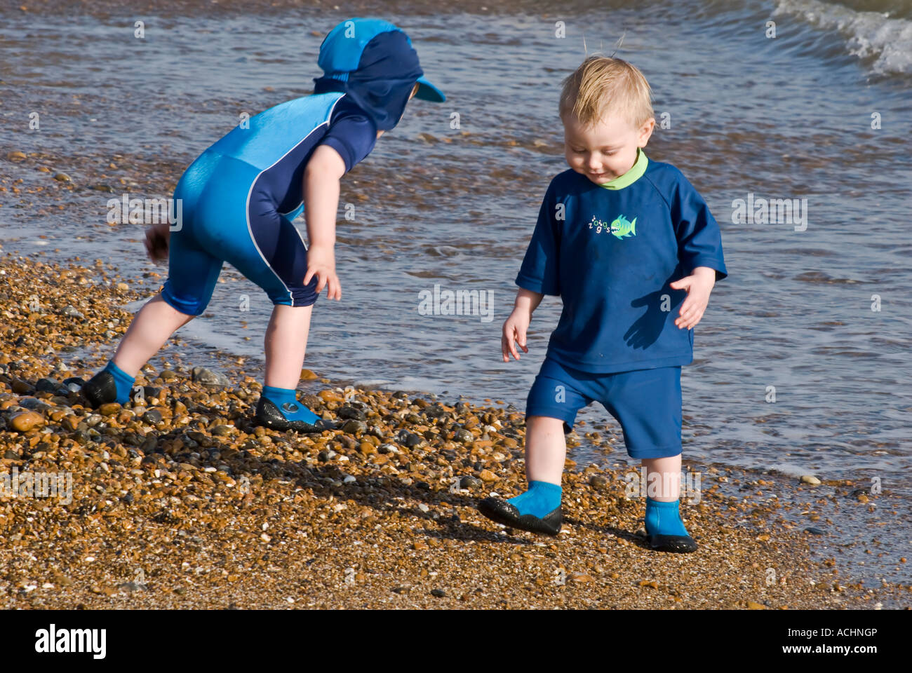 Two toddlers playing in the sea Stock Photo - Alamy
