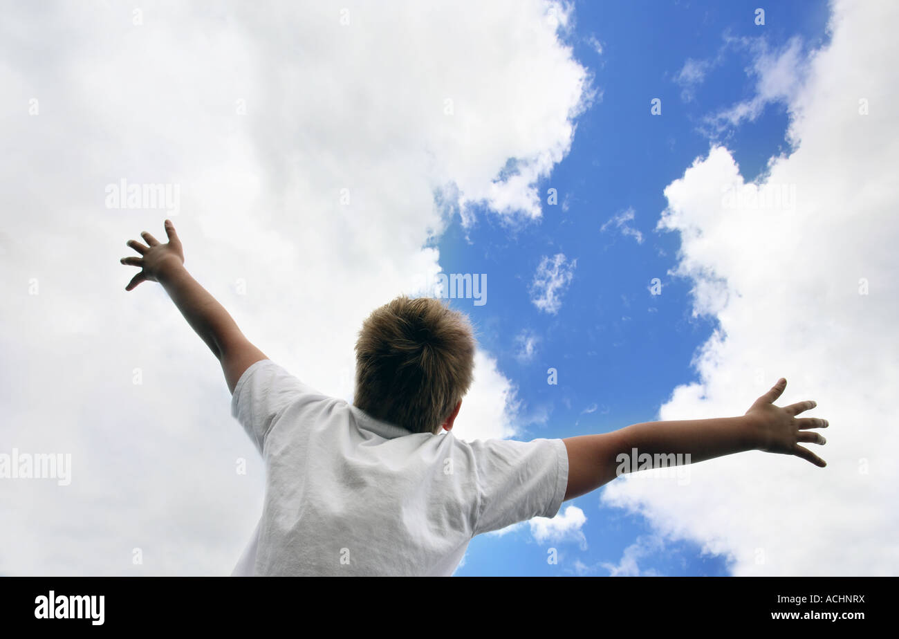 Boy with the open hands to the sky Stock Photo - Alamy