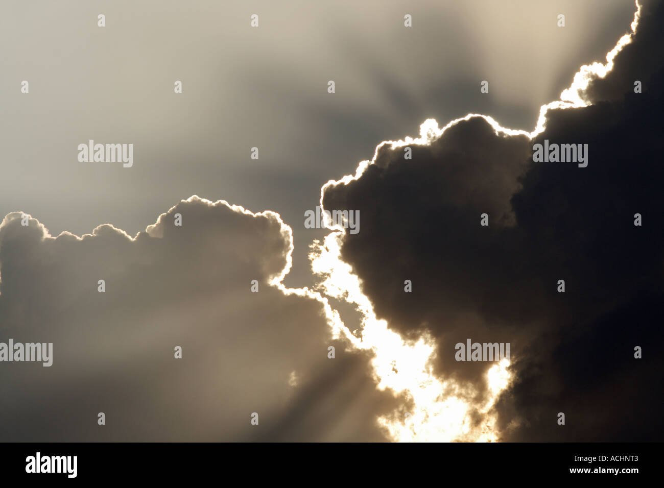 Sun behind storm clouds Stock Photo - Alamy