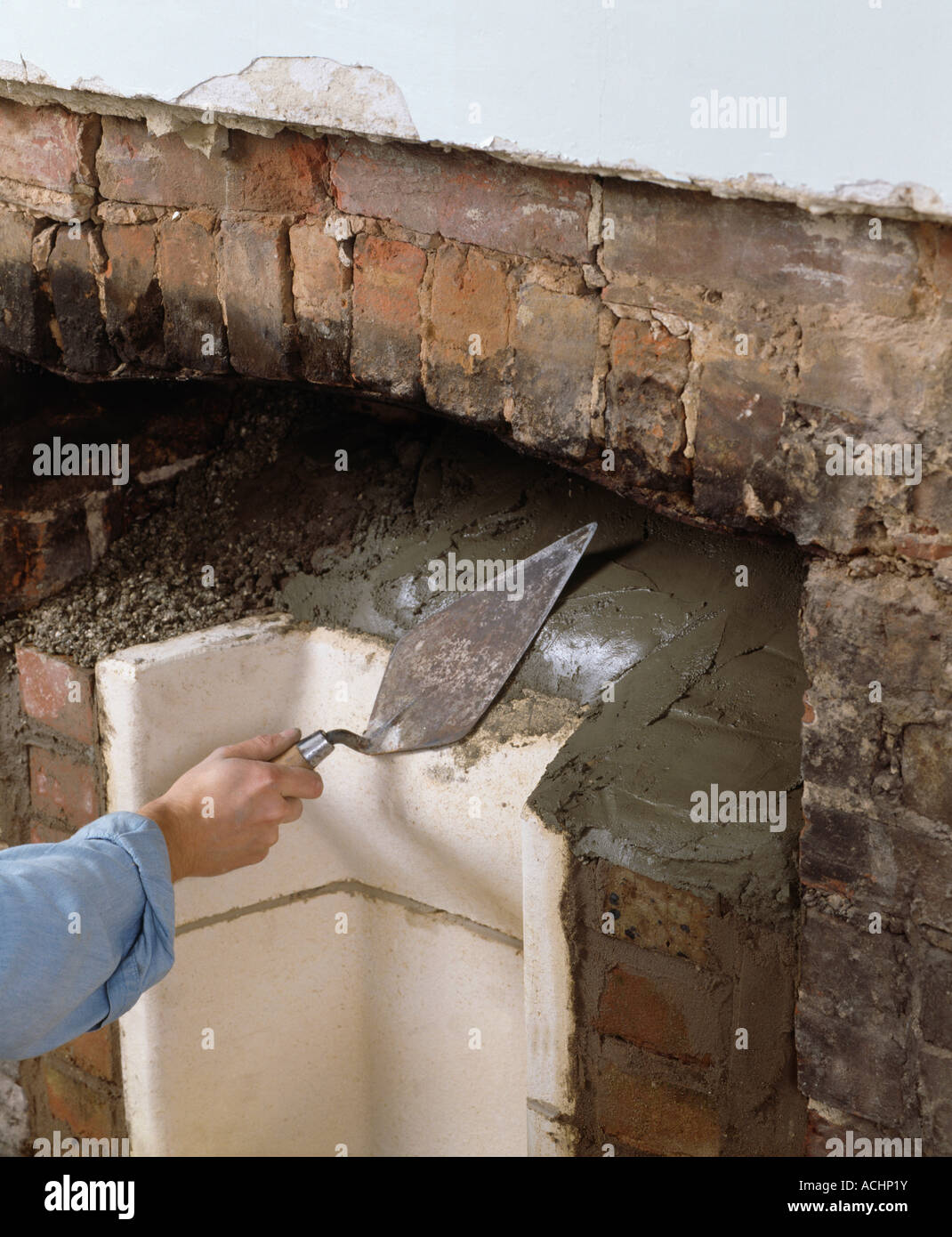 Close up of hands applying cement with trowel to fireplace Stock Photo ...