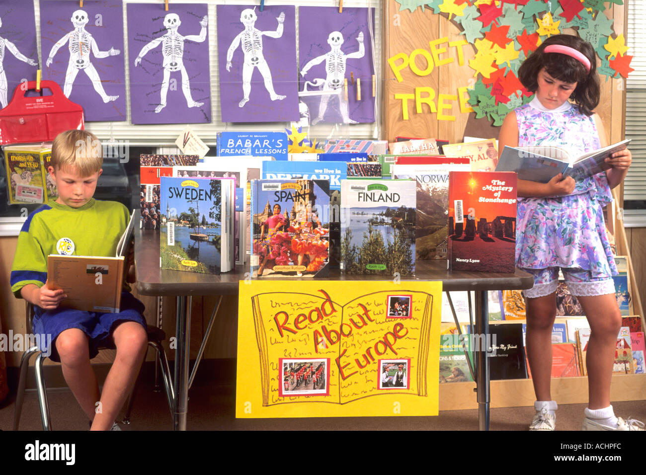 Schoolchildren reading about Europe in elementary school class Stock ...