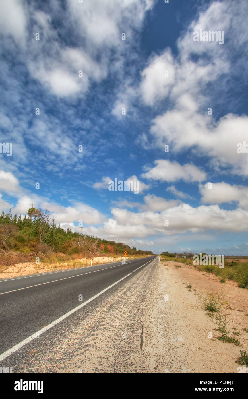 Landscape of endless countryside road with blue sky and clouds in ...