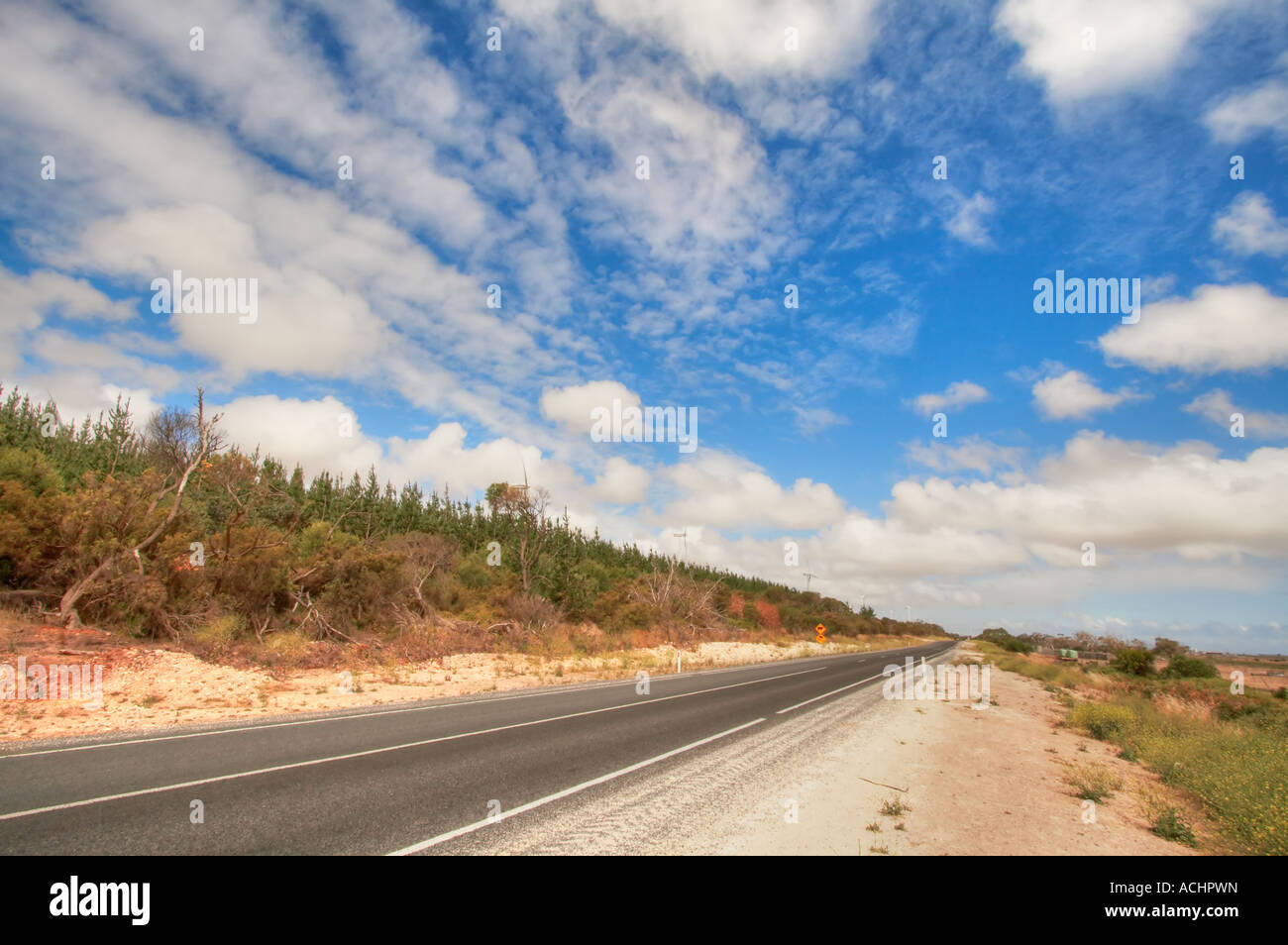 Landscape of endless countryside road with blue sky and clouds Stock ...