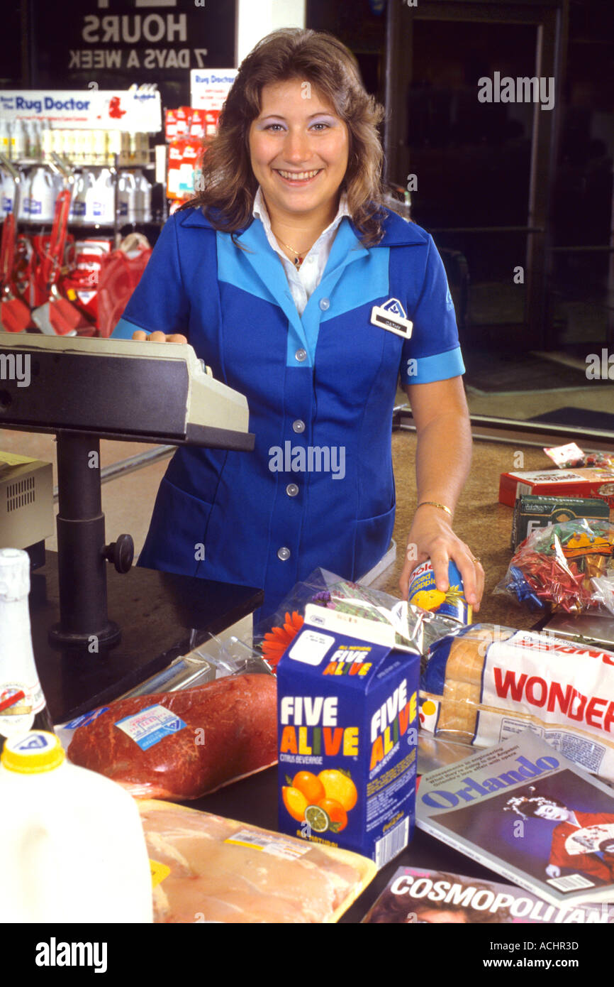 Happy checkout girl at local grocery store Stock Photo - Alamy