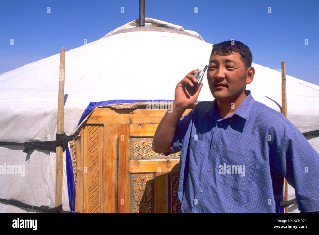 Nomadic Villager next to Ger on Cell Phone in Mongolia Stock Photo - Alamy