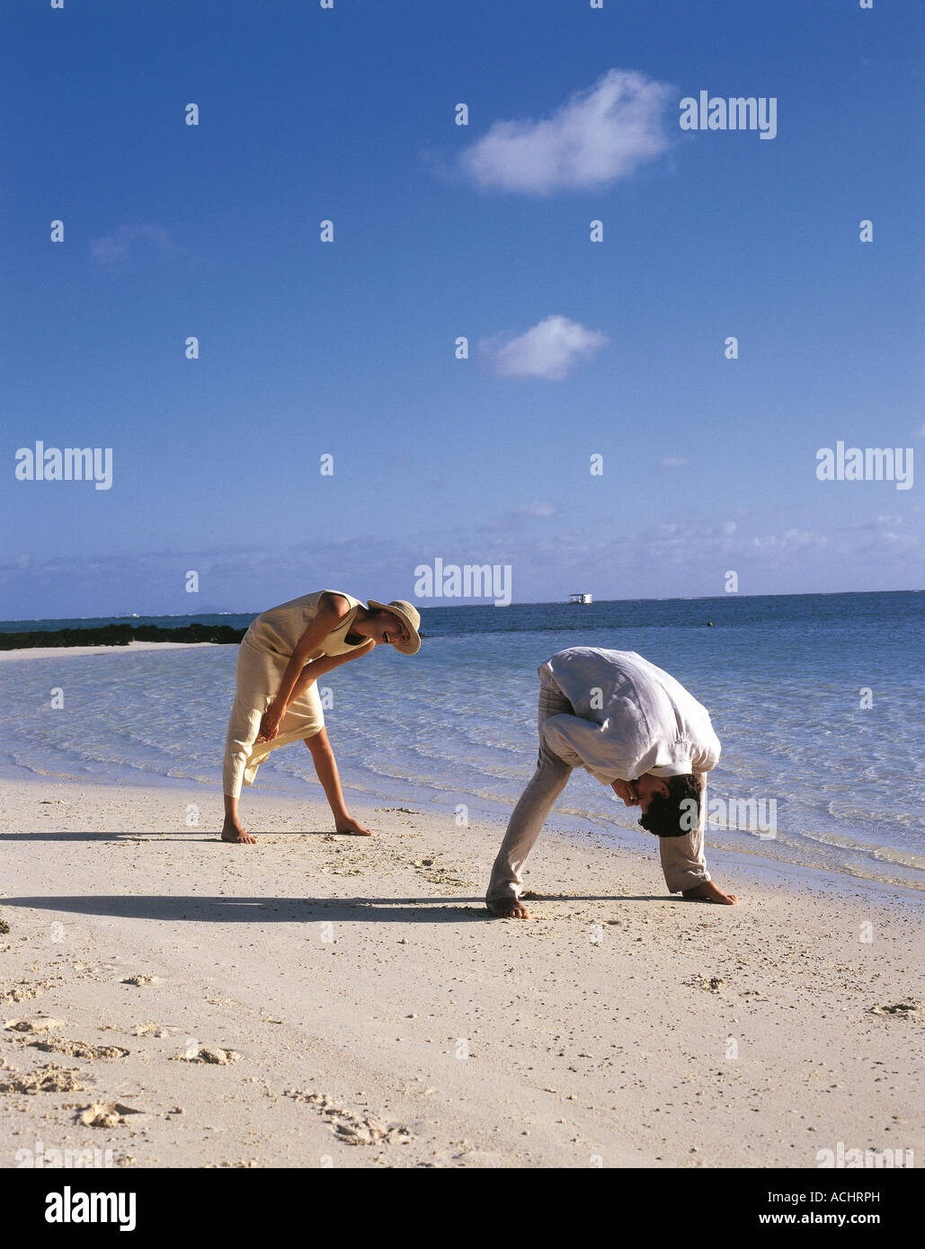 Couple smiling on the beach head down Stock Photo - Alamy