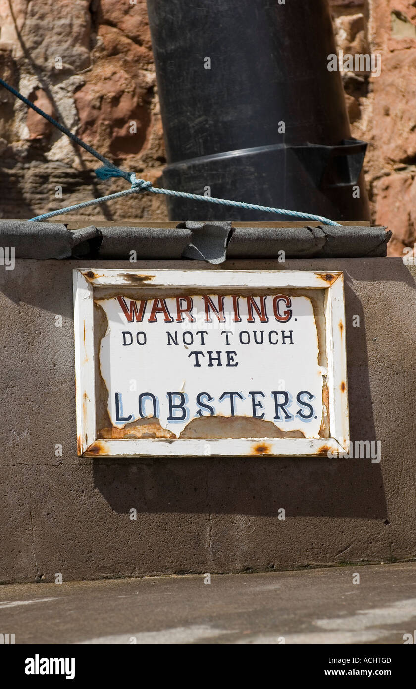 Sign "Do no Touch the lobsters" on an old fashioned lobster tank in the ...