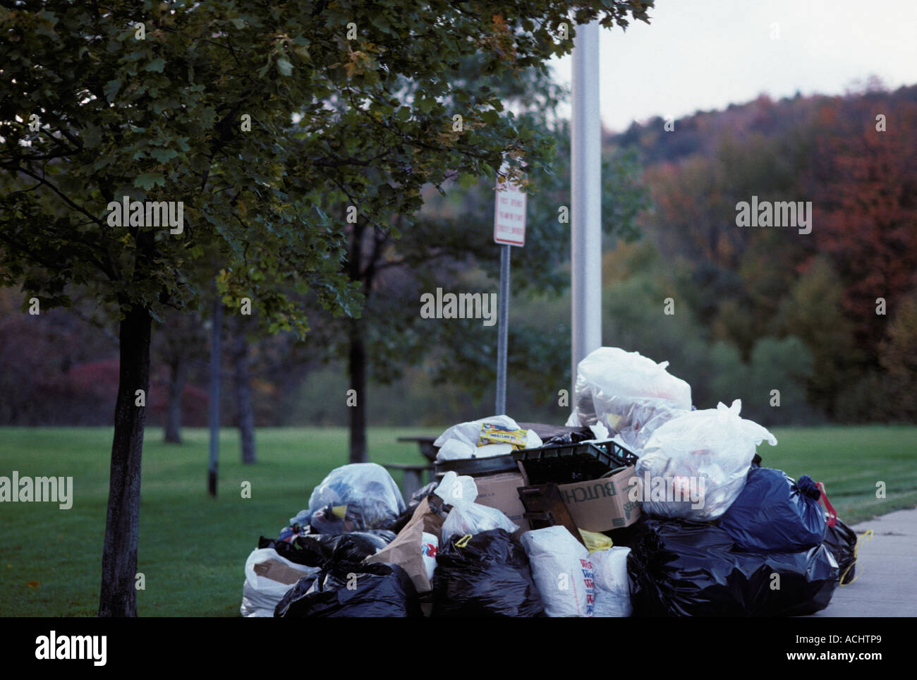 A pile of trash sits on a curb Stock Photo - Alamy