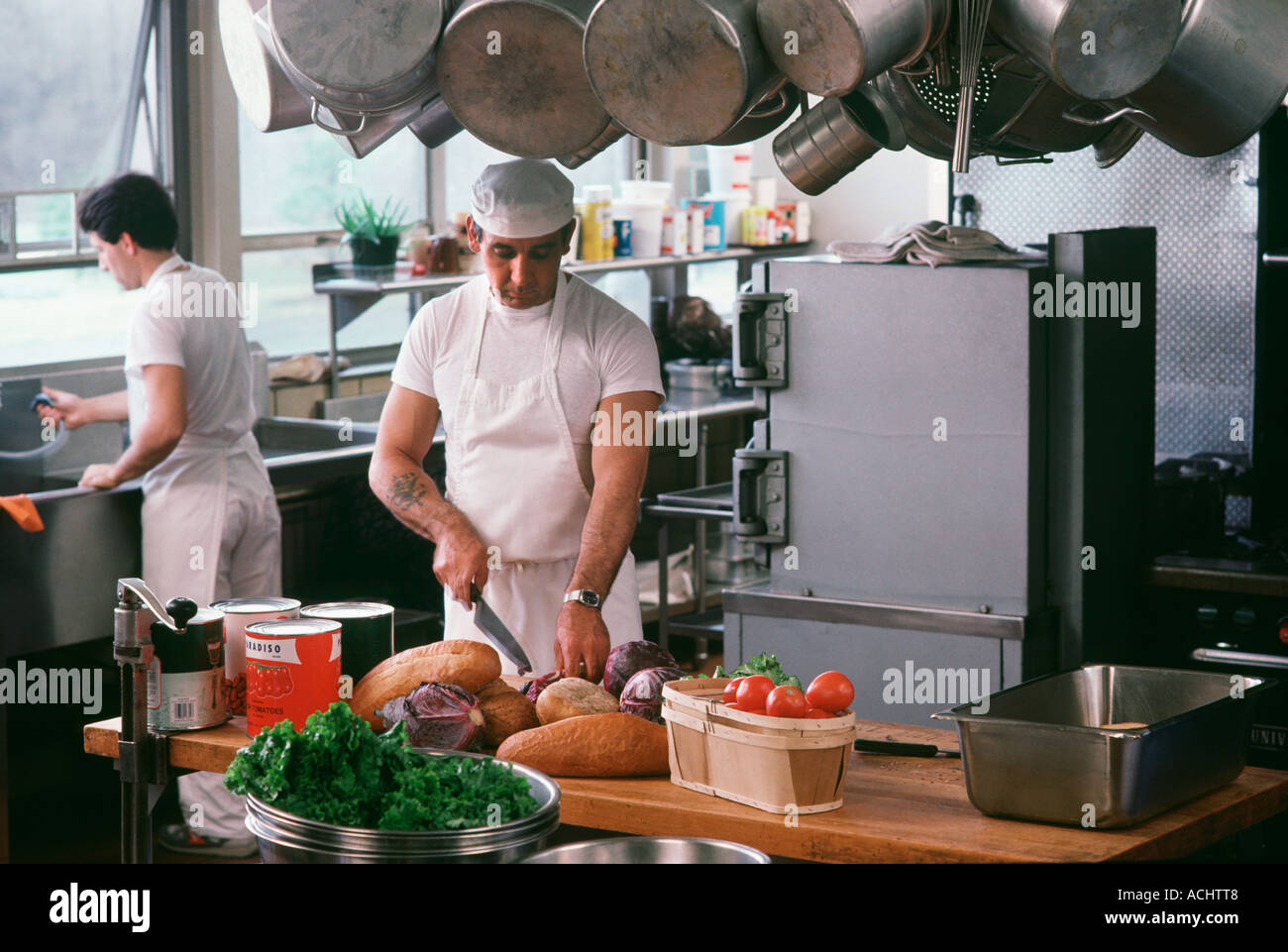 Two Caucasian food service workers in commercial kitchen Stock Photo ...