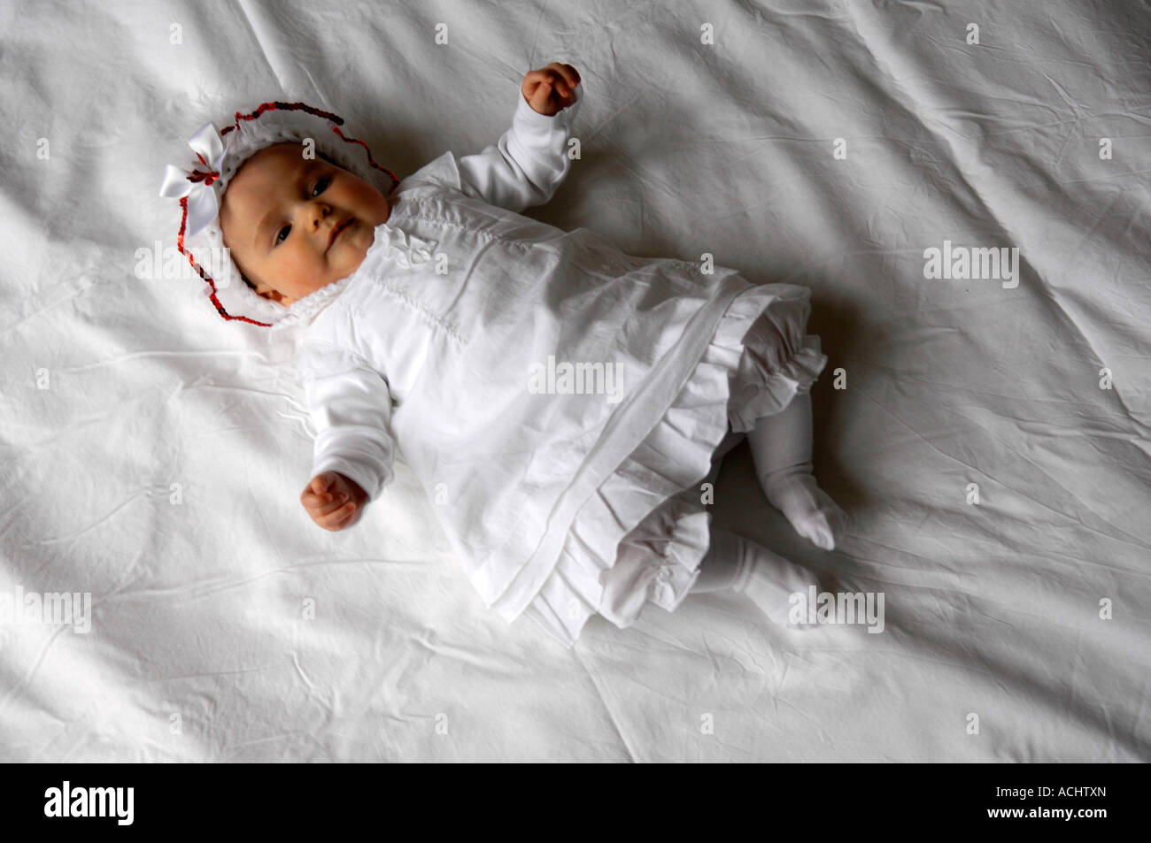 baby bonnet hat white red portrait face child infant colour color cute ...