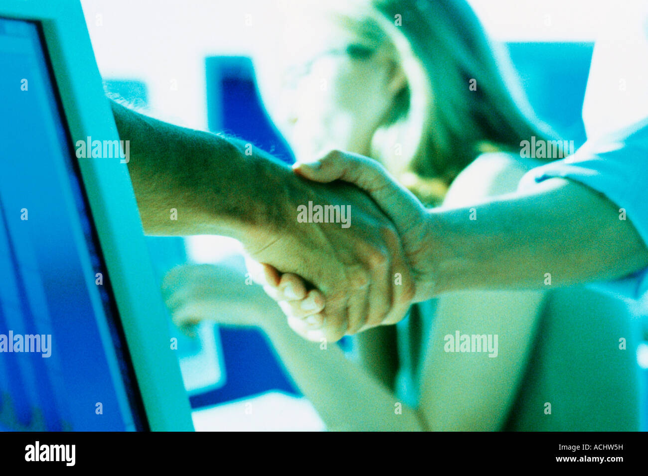 Handshaking computer screen woman working behind Stock Photo - Alamy
