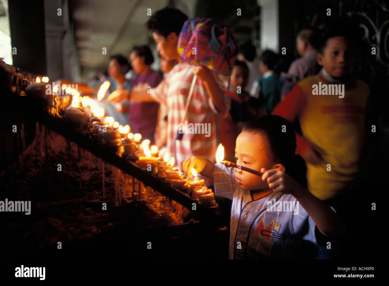 Philippines Cebu Island Boys lights devotional candles at Basilica del ...