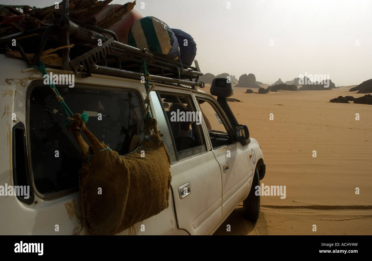 A Tuareg Landcruiser crosses the awesome Tassili N Ajjer landscape in ...