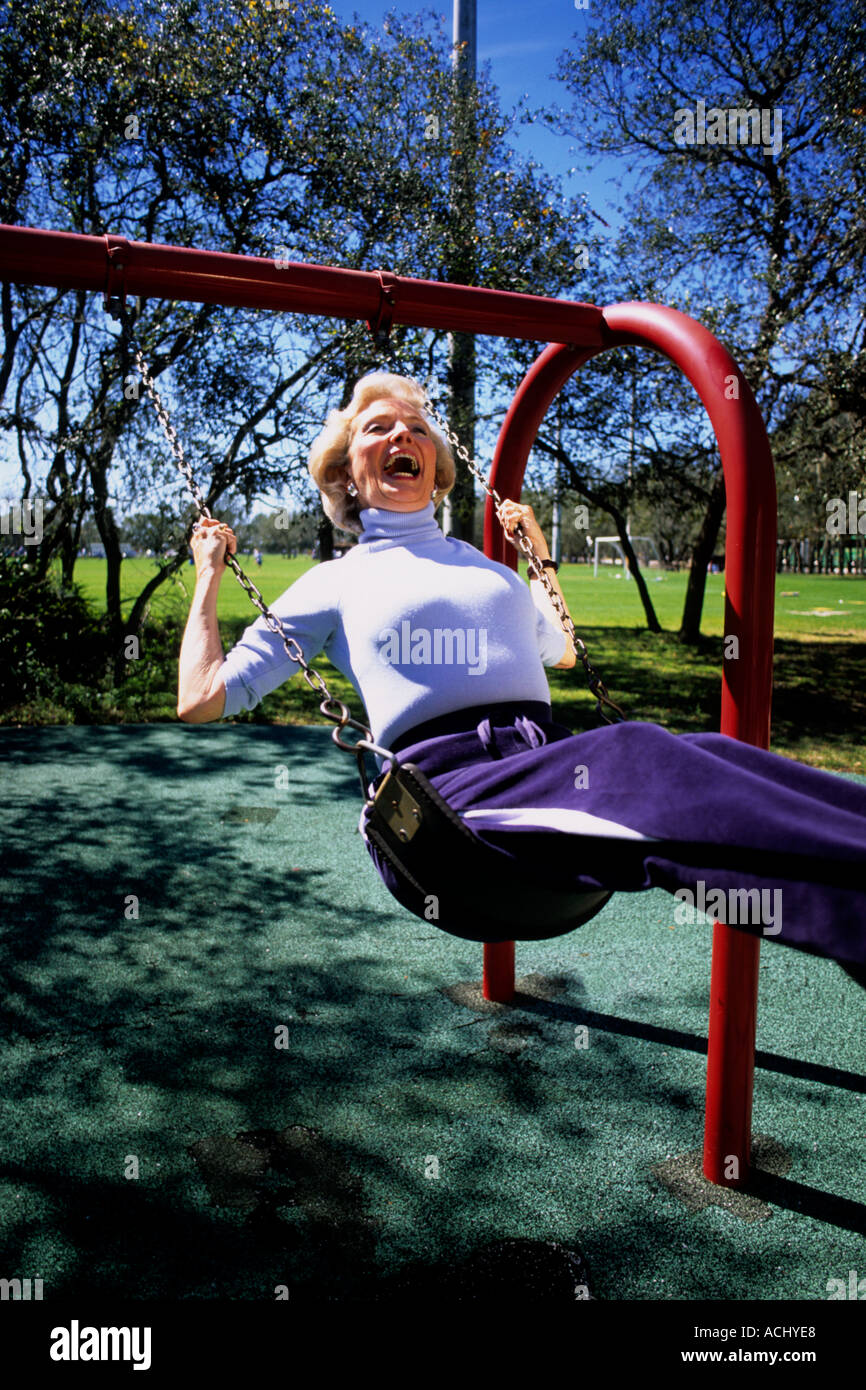 Healthy retired couple in their 70s on a swing Stock Photo - Alamy