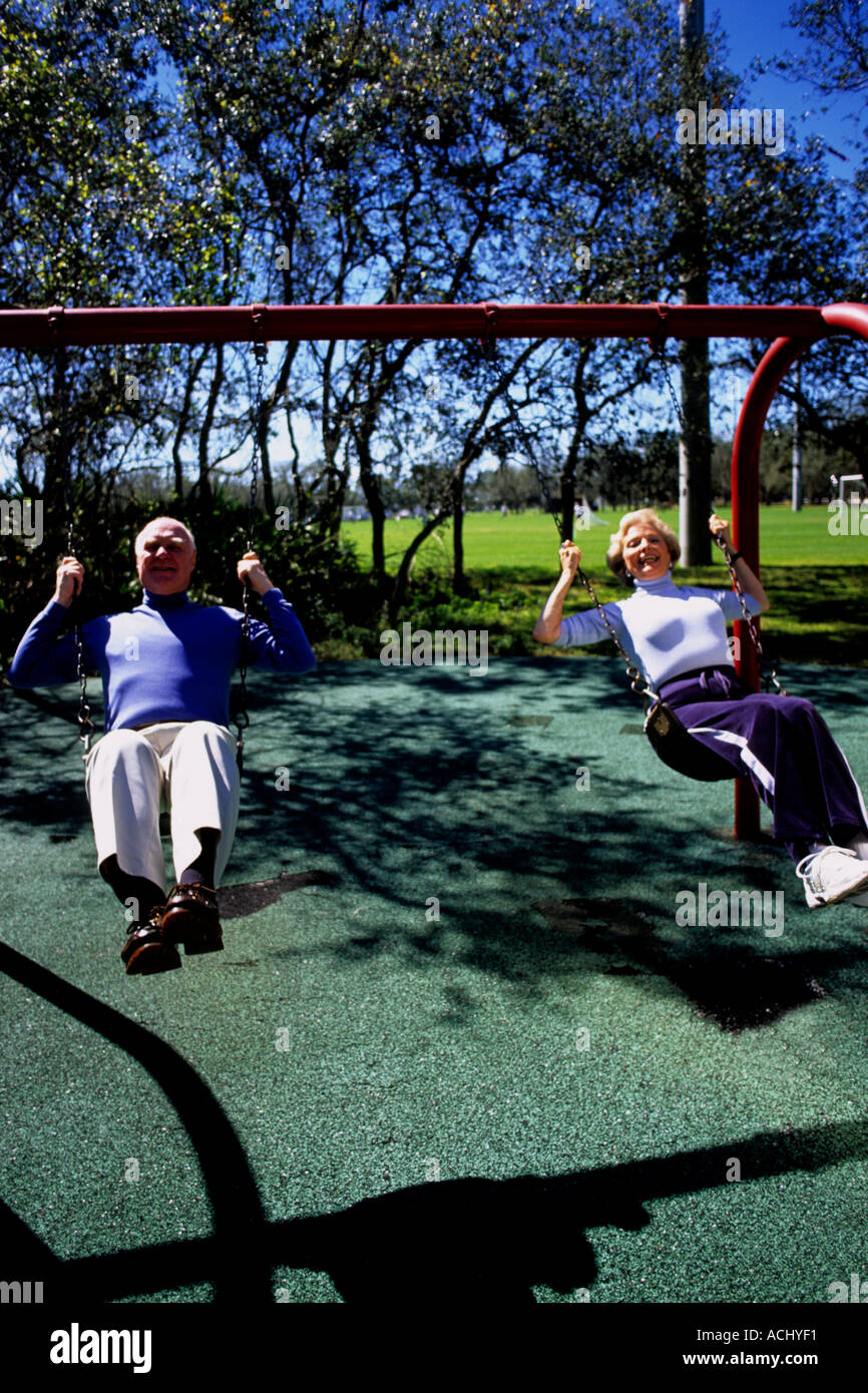 Healthy retired couple in their 70s on a swing Stock Photo - Alamy