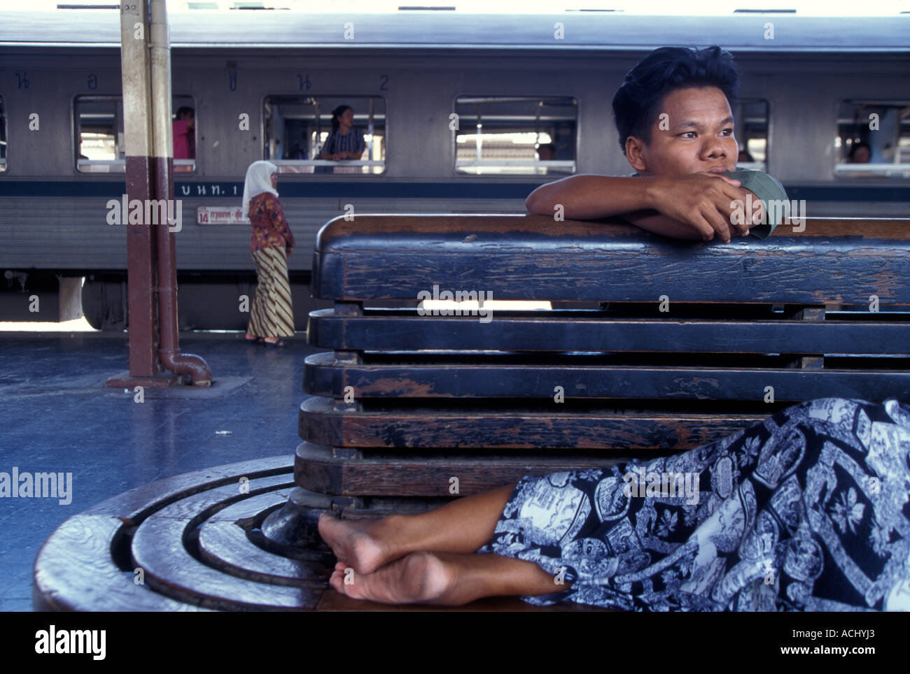 Thailand Bangkok Man rests on bench at Bangkok Train Station Stock ...