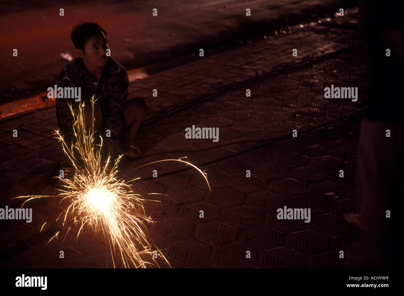 Asia Vietnam Hanoi Worker sends up spray of sparks while cutting steel ...