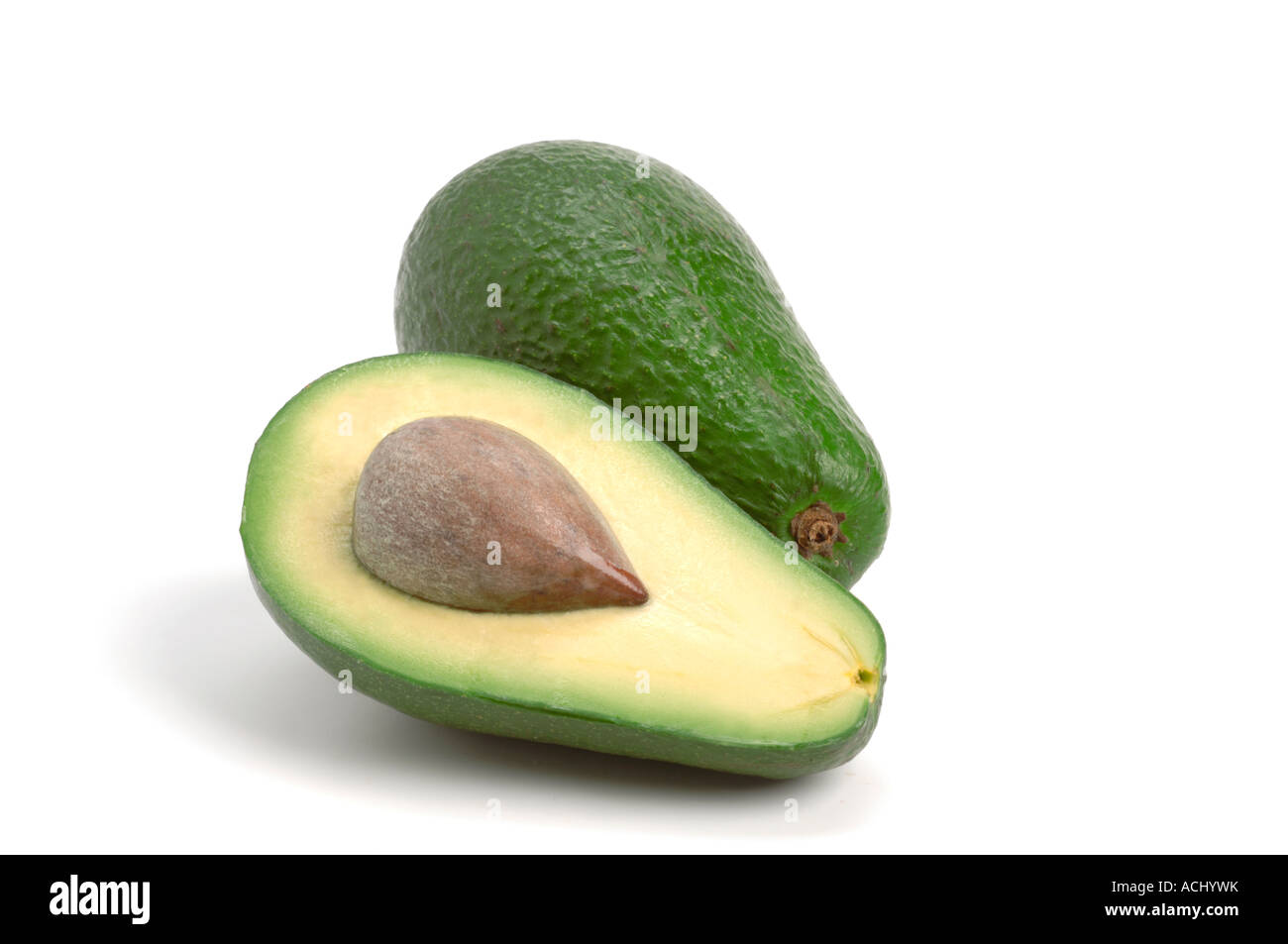 Two Avocados one halved Stock Photo - Alamy
