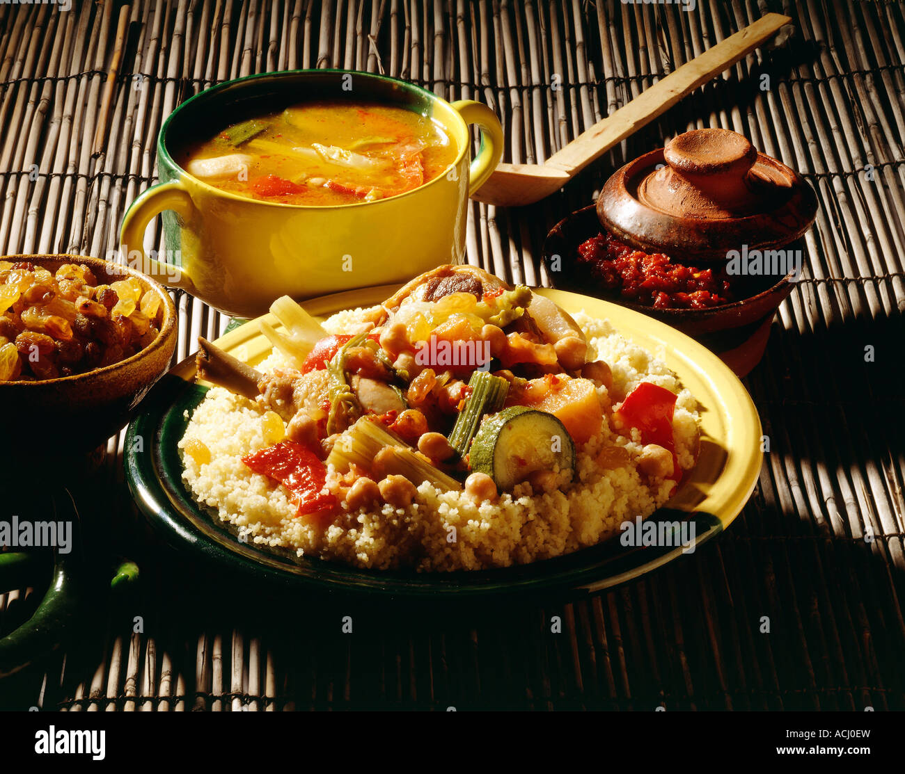 Composition couscous in plate sauce bowl pepper puree raisins + recipe ...