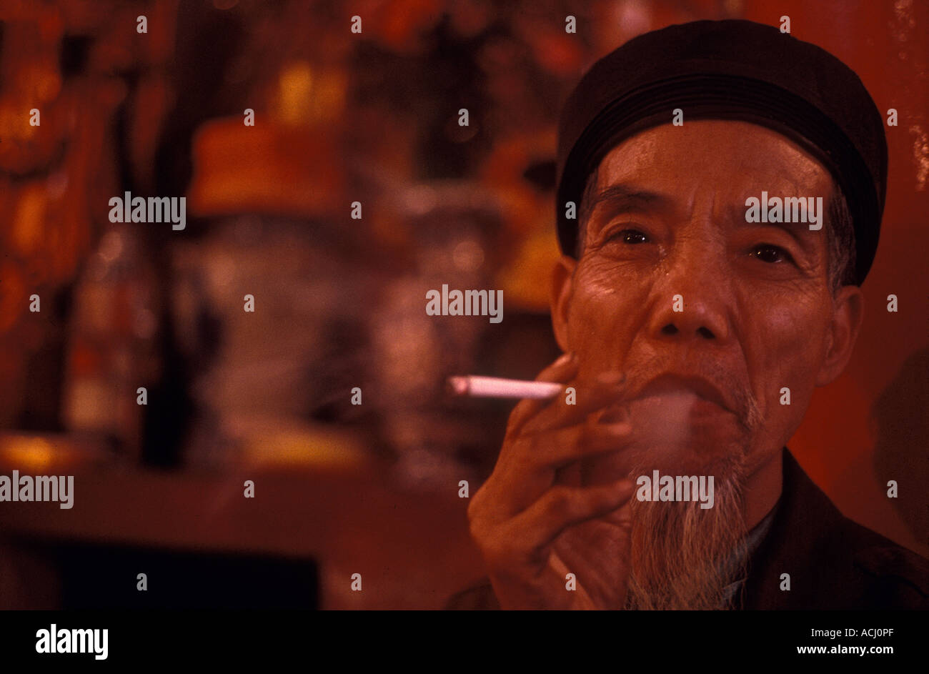 Asia Vietnam Buddhist monk smoking cigarette at small temple along Yen ...