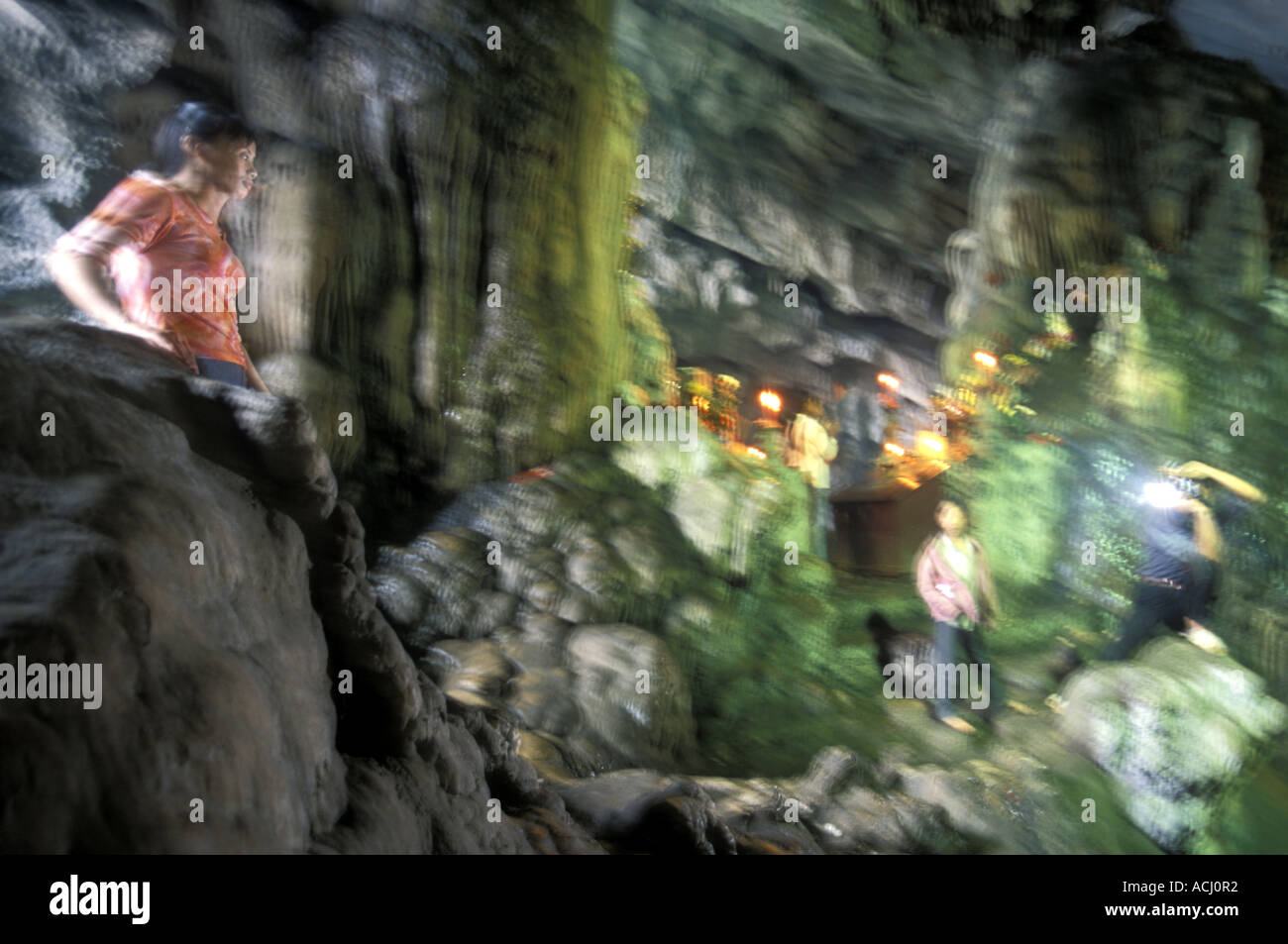 Asia Vietnam Woman poses for snapshots inside limestone cave entrance ...