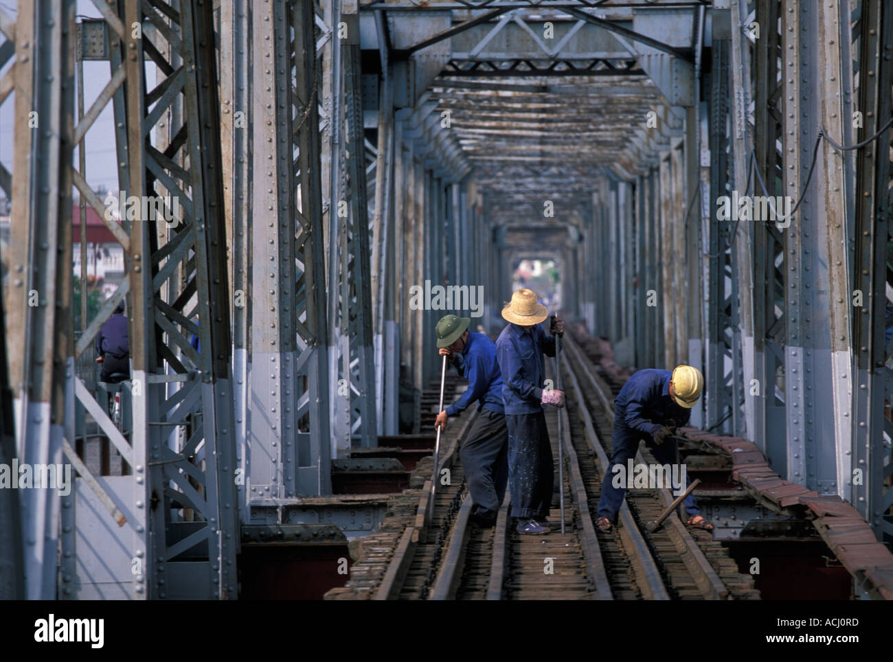 Asia Vietnam Hanoi Railroad workers at work on tracks crossing Long ...