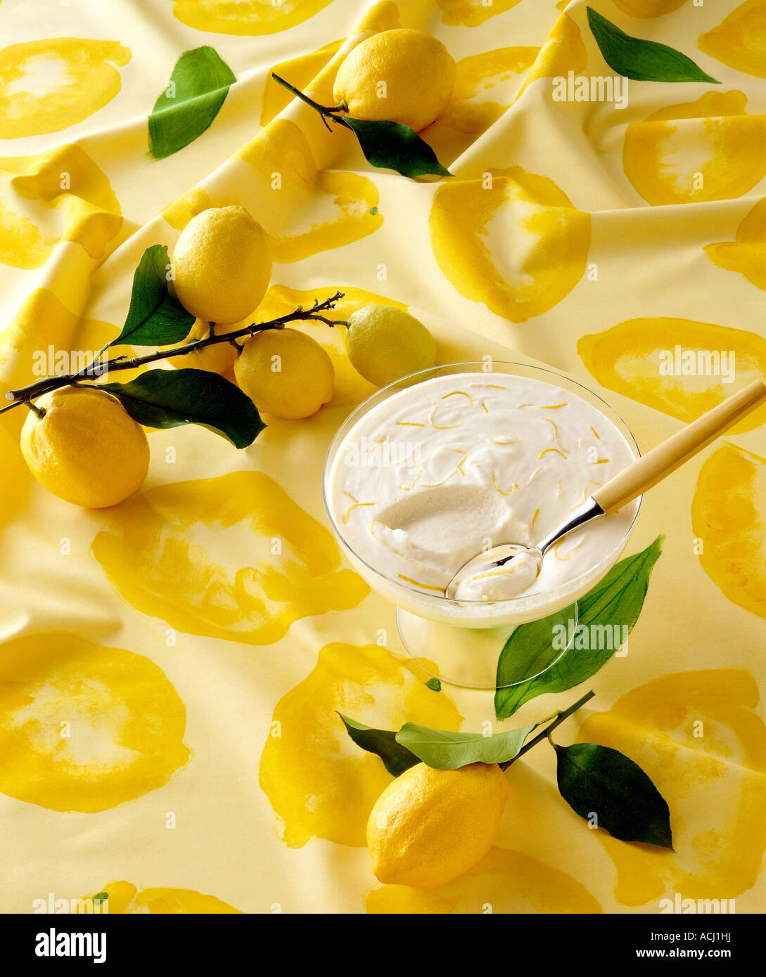 Lemon mousse in glass cup cloth and lemons Stock Photo - Alamy