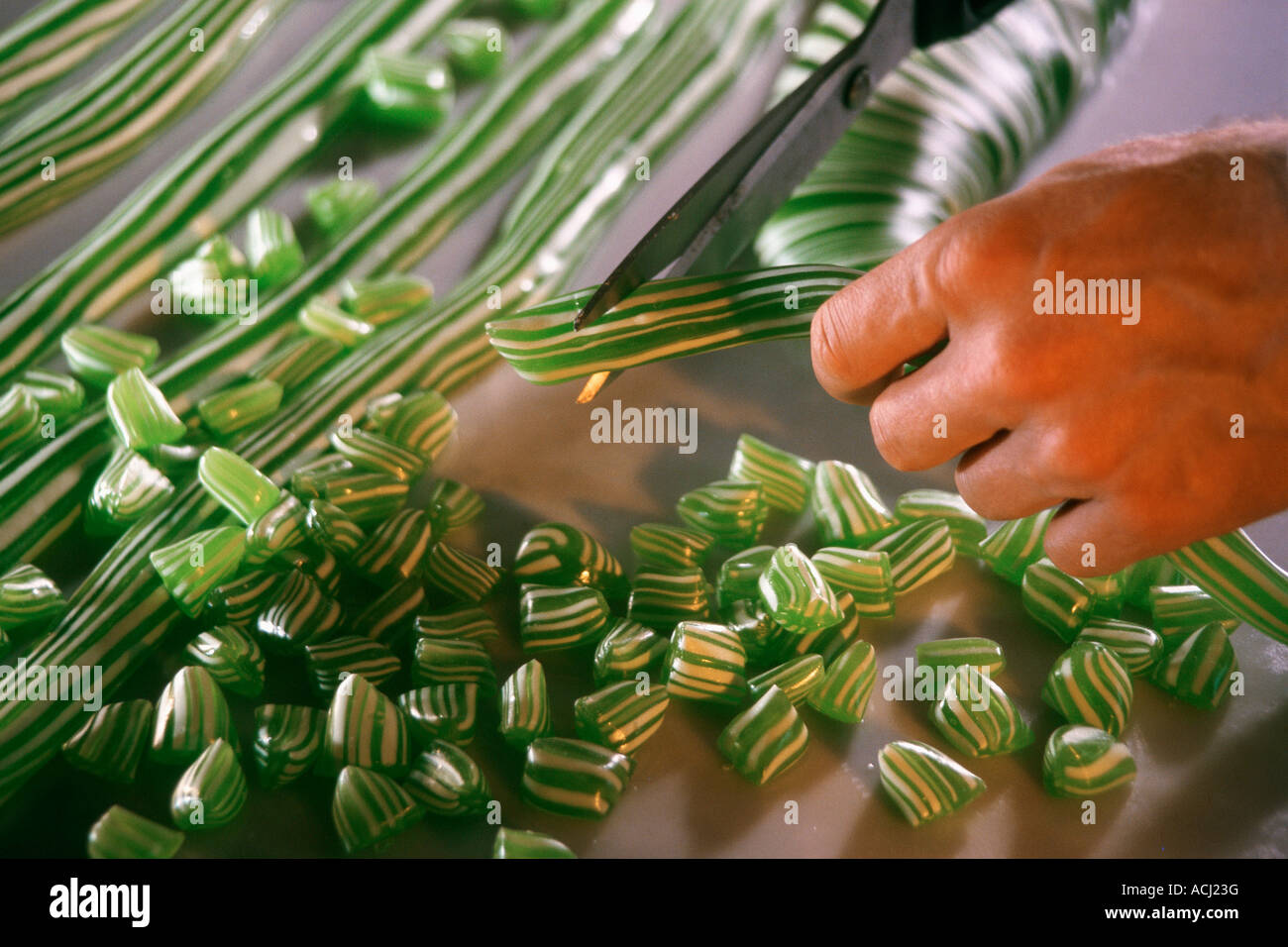 Burnt-sugar sweets making hand of man Stock Photo - Alamy