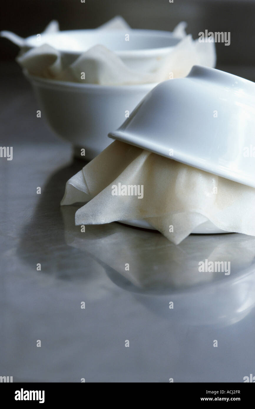 White bowls turned down in metalic plate Stock Photo - Alamy