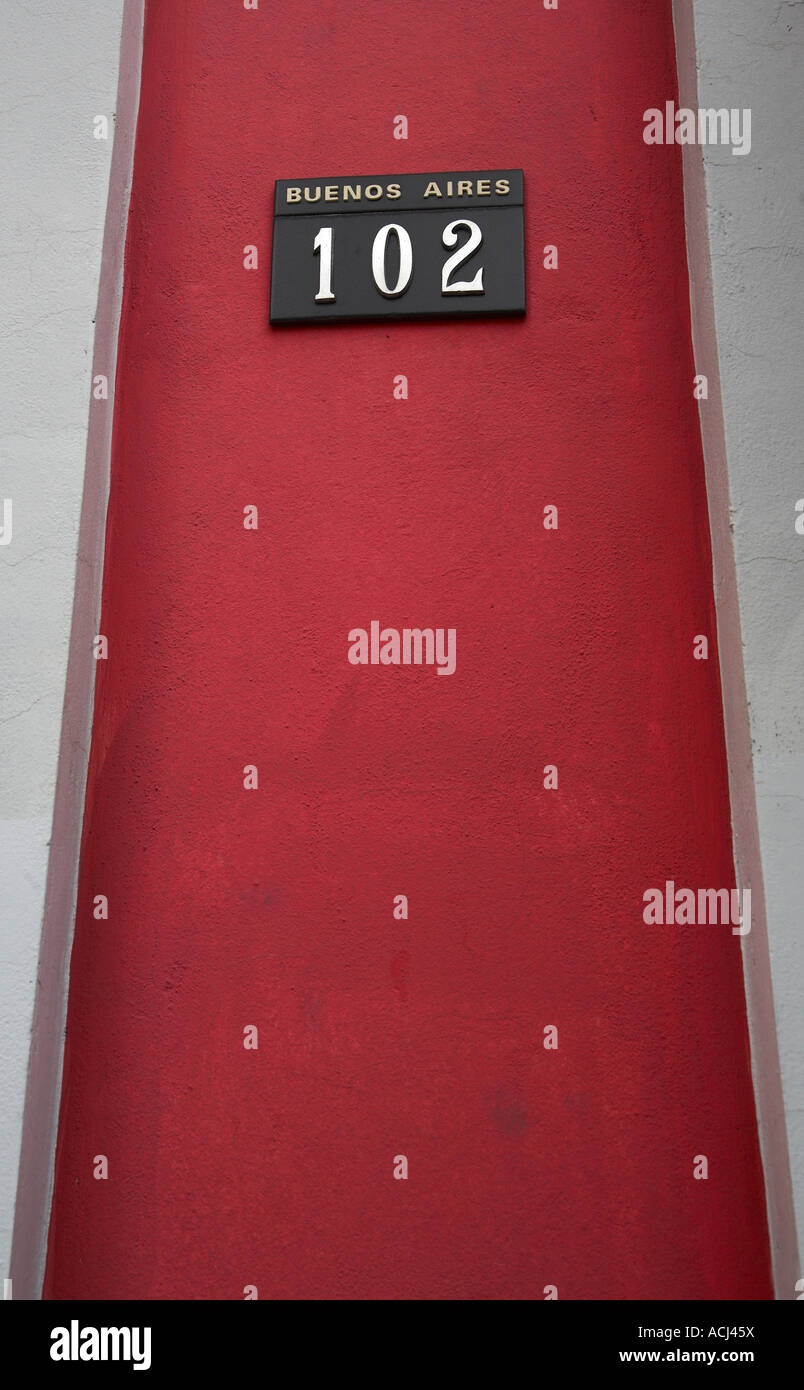 house number 102 on red wall Stock Photo - Alamy