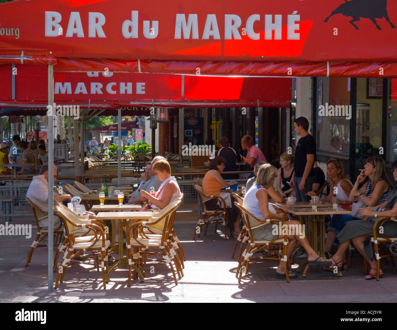 France Bar du Marché in Arles with tourists sitting outside in sunshine ...