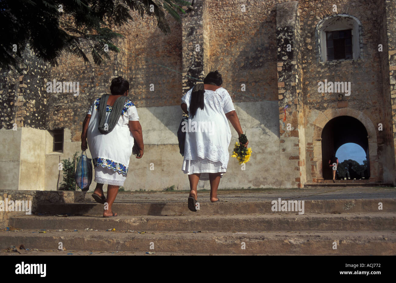 Maya women in traditional white linen clothing walk to church Yucatan ...
