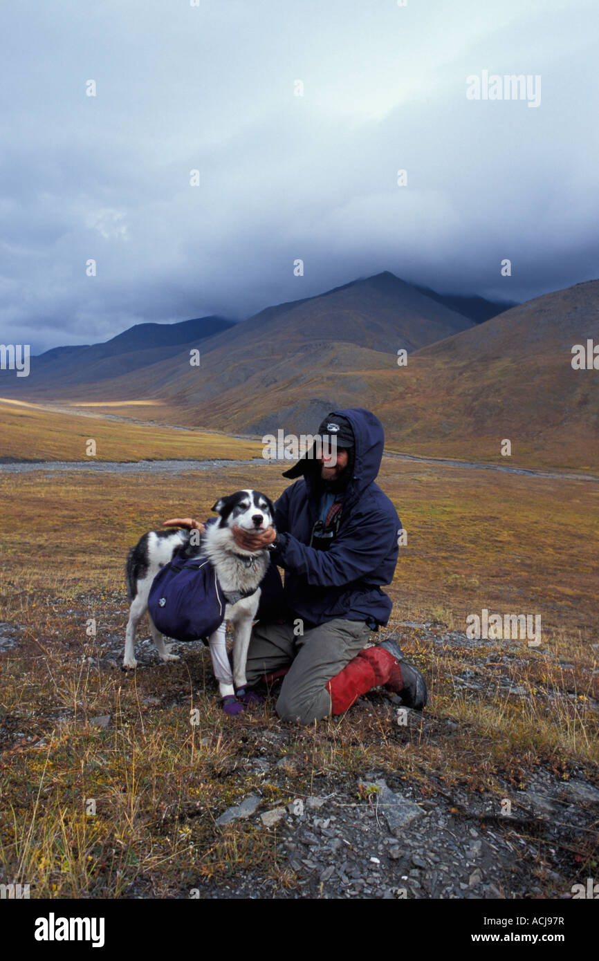 Alaska wilderness guide and dog resting in Gates of the Arctic National ...