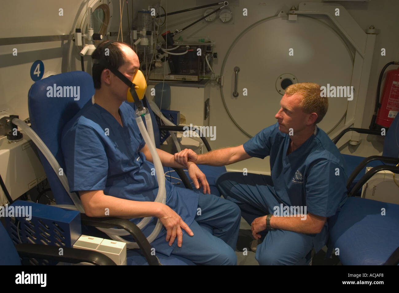 Patient undergoes hyperbaric oxygen treatment in recompression chamber ...