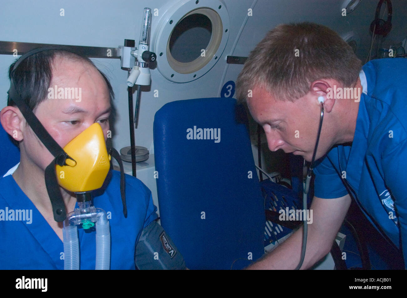 Patient undergoes hyperbaric oxygen treatment in recompression chamber ...