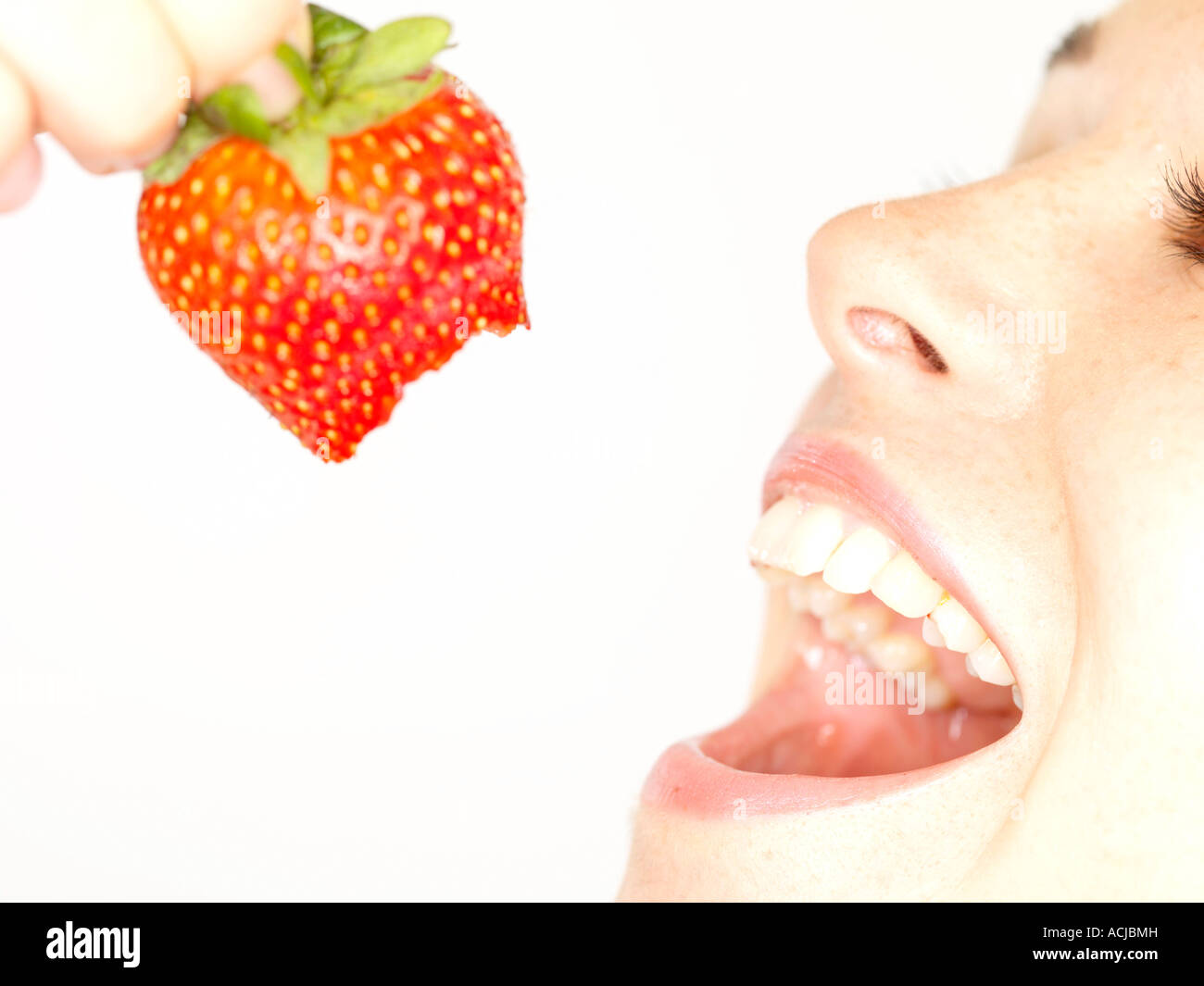Young Woman Eating Strawberry Model Released Stock Photo - Alamy