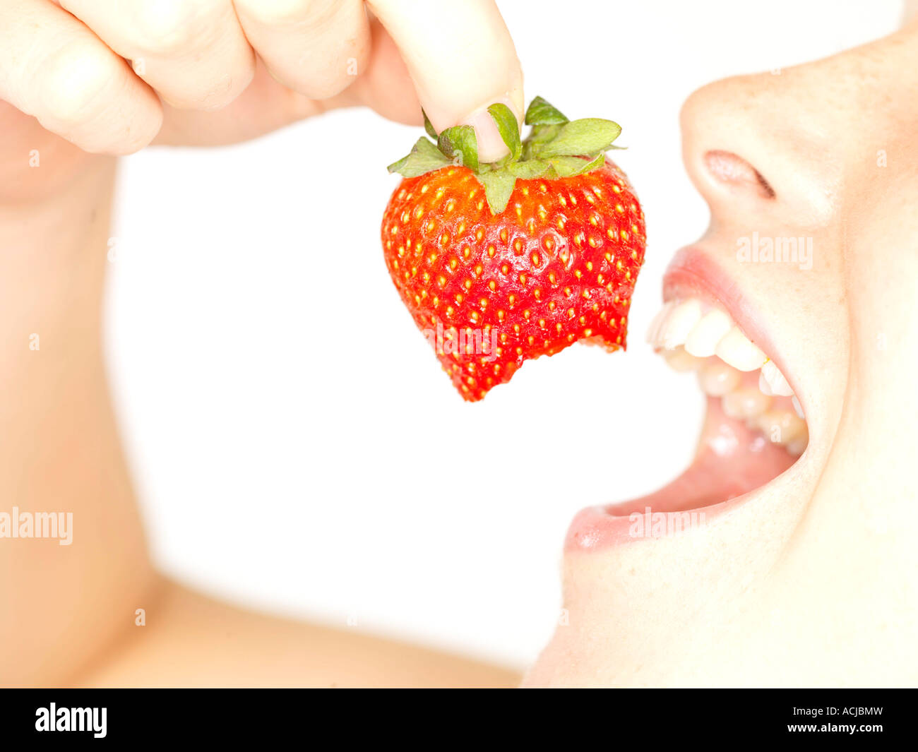Young Woman Eating Strawberry Model Released Stock Photo - Alamy