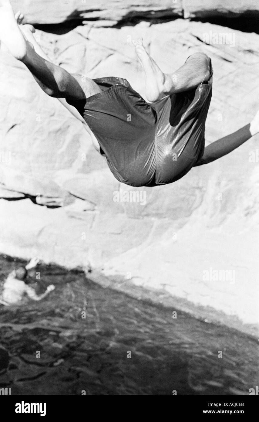 A man doing a backflip into water Stock Photo - Alamy