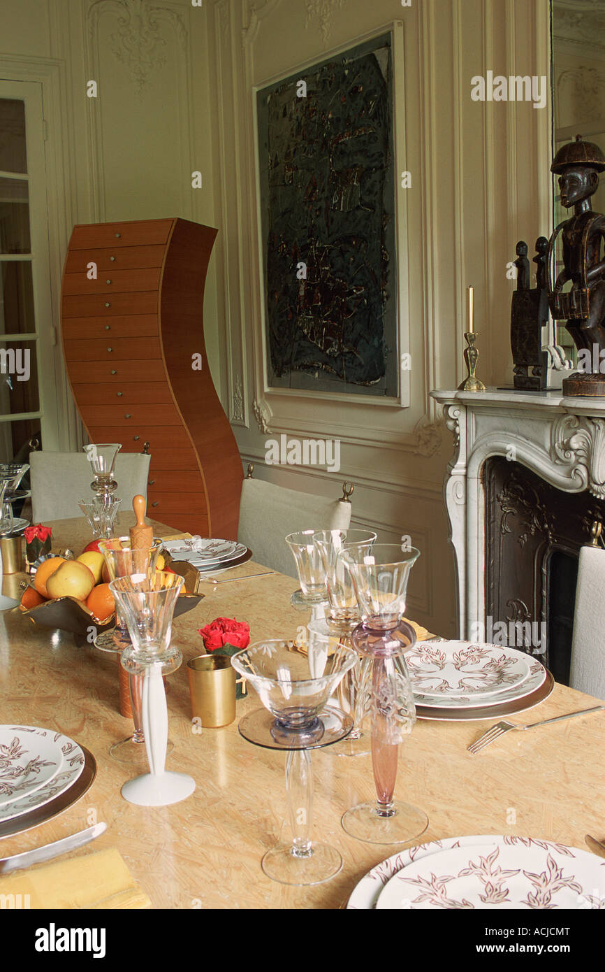 Table laid cristal glass bookcase in background Stock Photo - Alamy