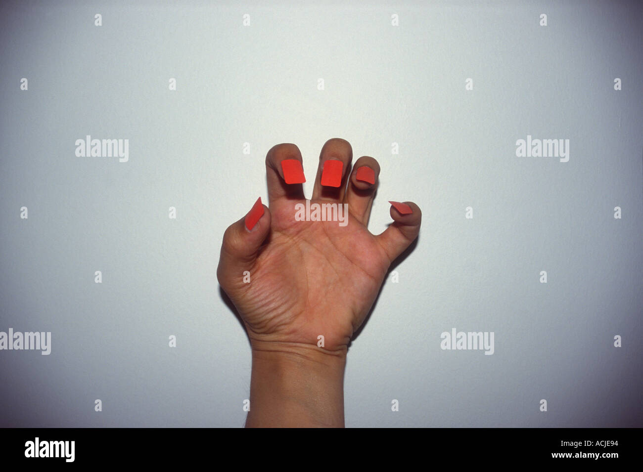 A hand with fake fingernails Stock Photo - Alamy