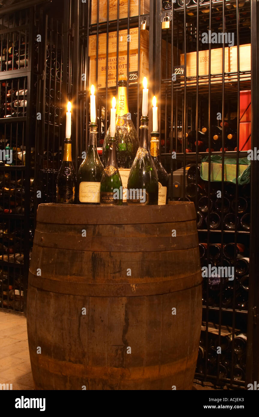 Wire cages with private wine collections and a standing barrel with ...