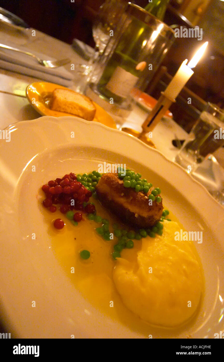 A table with a candle and the Swedish food classic Wallenbergare a type ...