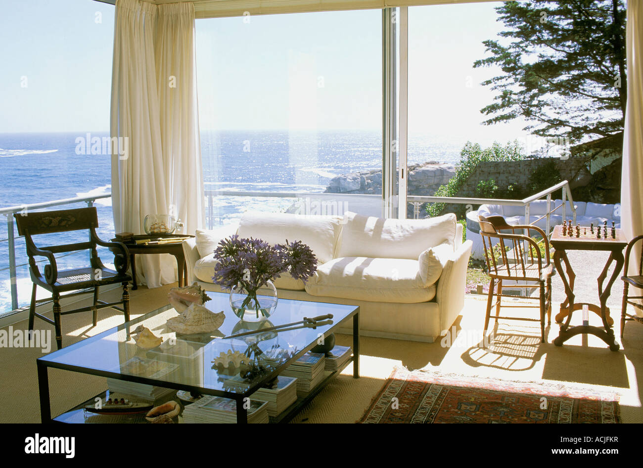 Living-room white couch coffee table bay window blue sky Stock Photo ...