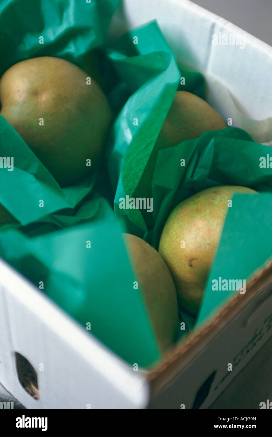 Pears in green paper interior Stock Photo - Alamy