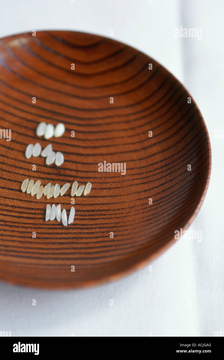 4 rice rows on wooden japanese plate interior Stock Photo - Alamy
